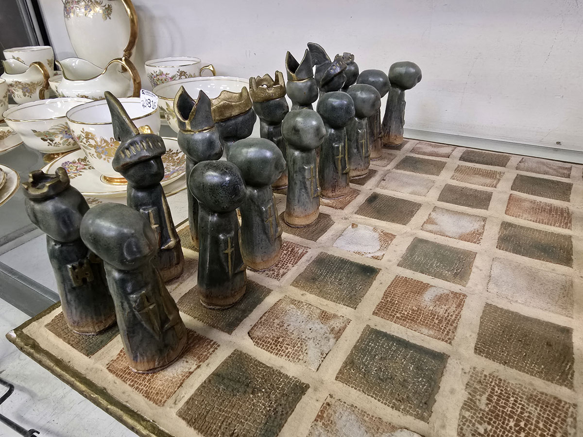 Lot 321 - A stone chess board along with a set of